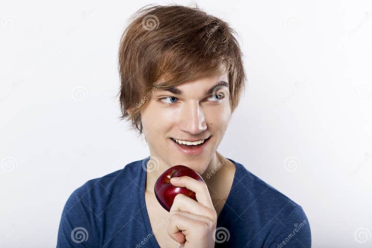 Young man eating a apple stock image. Image of casual - 23689257
