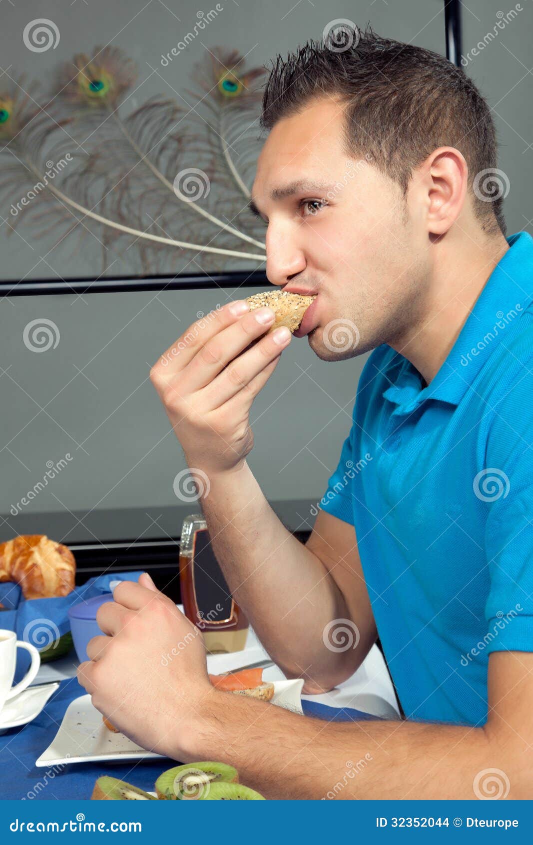 Young man eating breakfast stock photo. Image of grain - 32352044