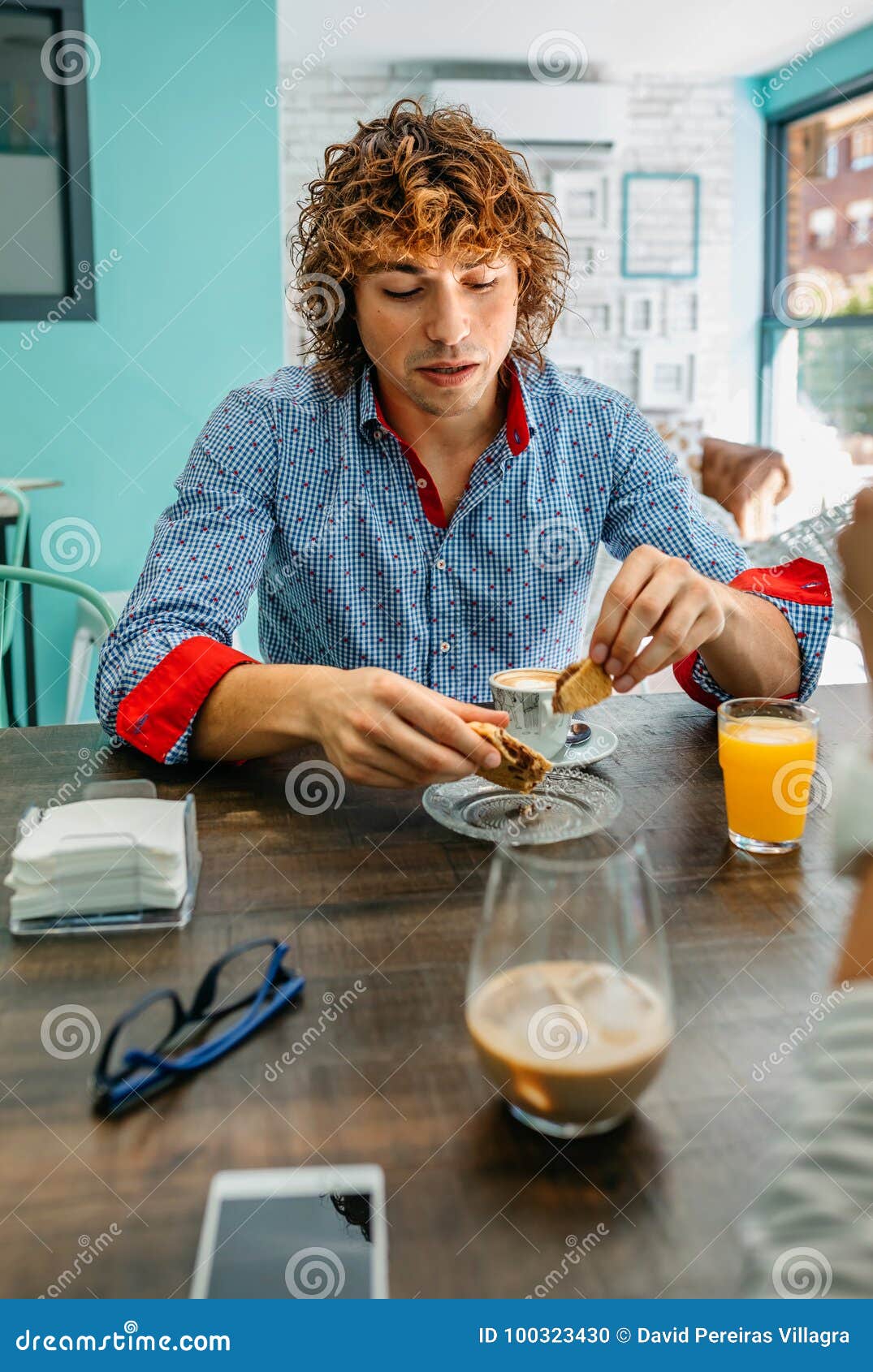 Young man eating breakfast stock photo. Image of food - 100323430