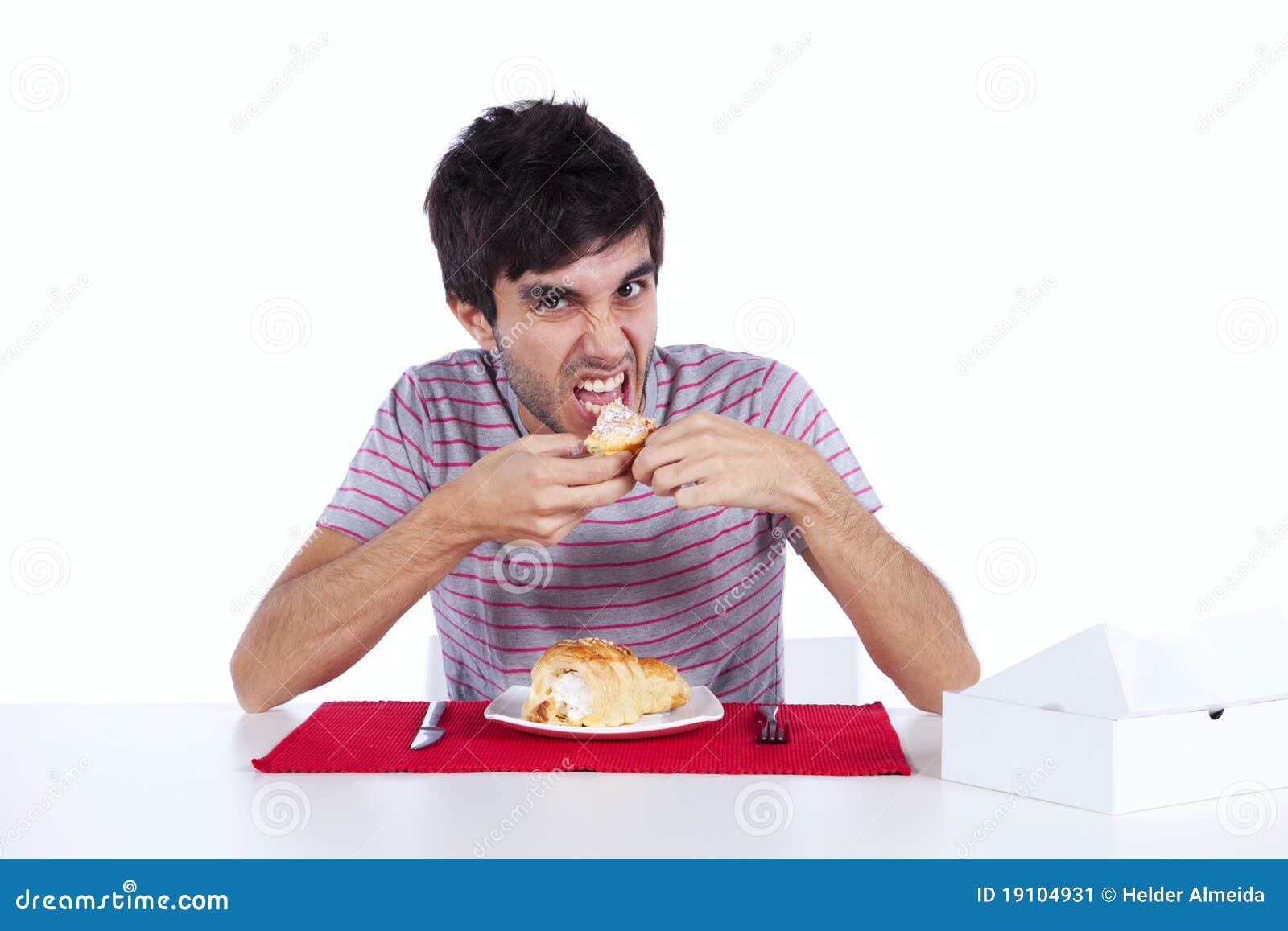 Young man eating a cake stock image. Image of calories - 19104931