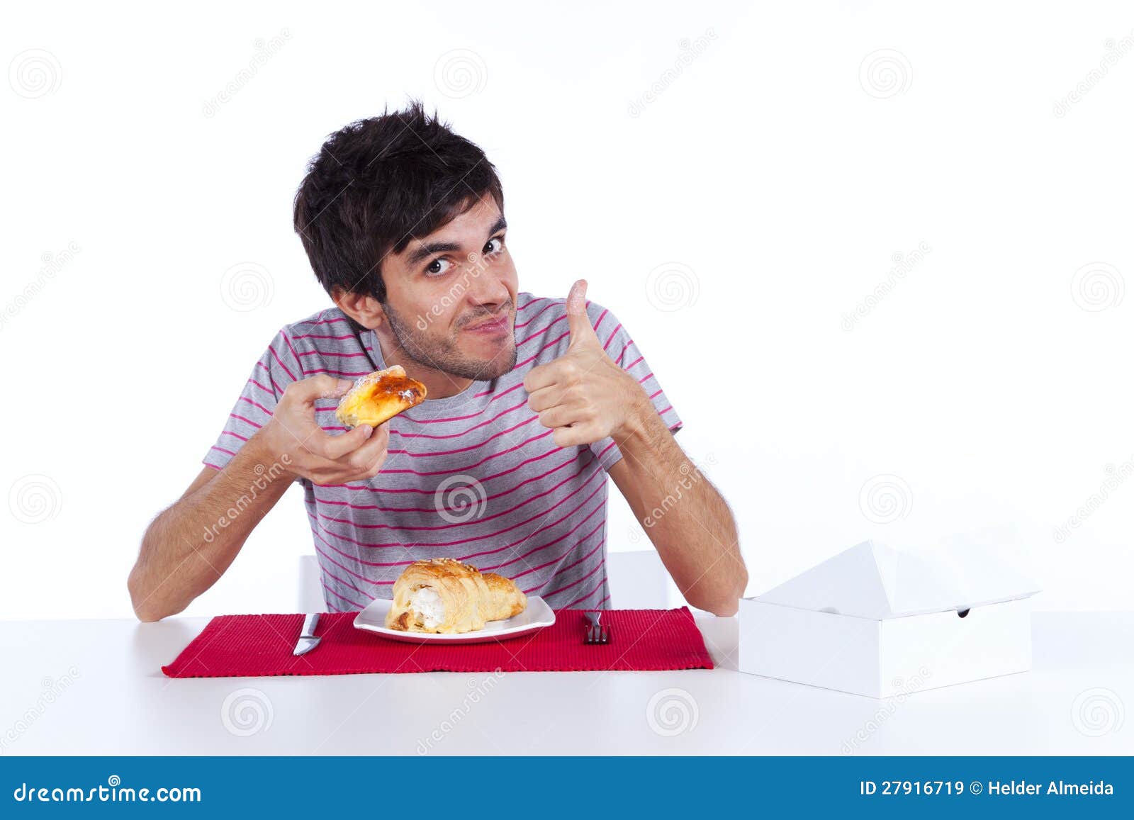 Young man eating a cake stock image. Image of junk, cream - 27916719