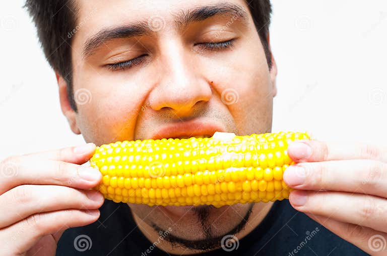 Young man eating corn stock photo. Image of eyes, male - 15680508