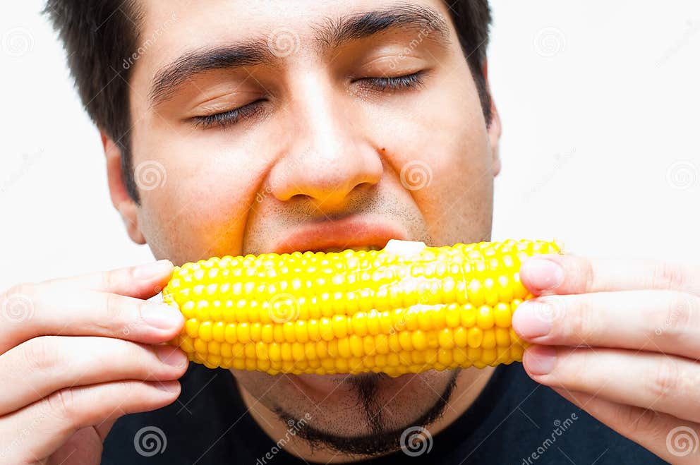 Young man eating corn stock photo. Image of eyes, male - 15680508