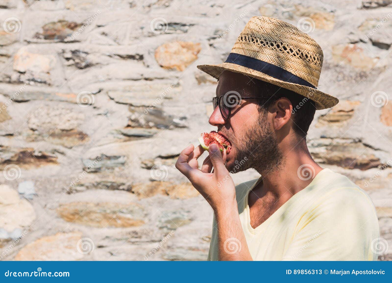 Young man eating fresh fig stock image. Image of food - 89856313