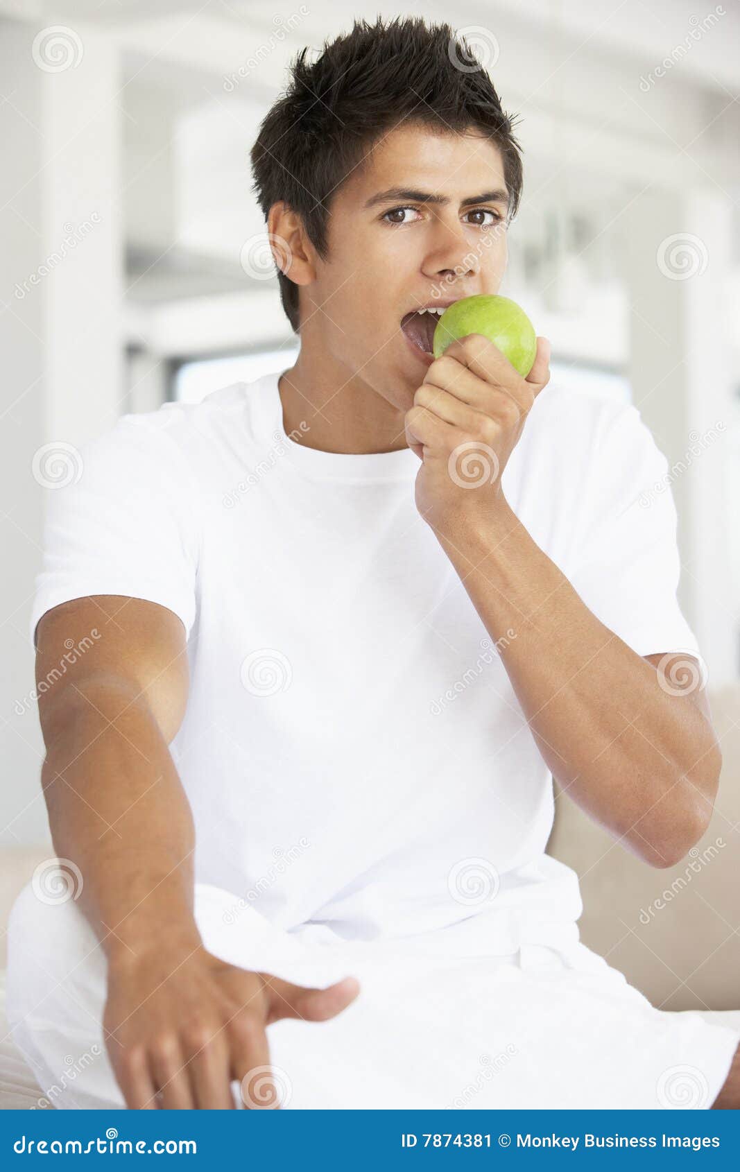 Young Man Eating a Green Apple Stock Image - Image of food, camera: 7874381