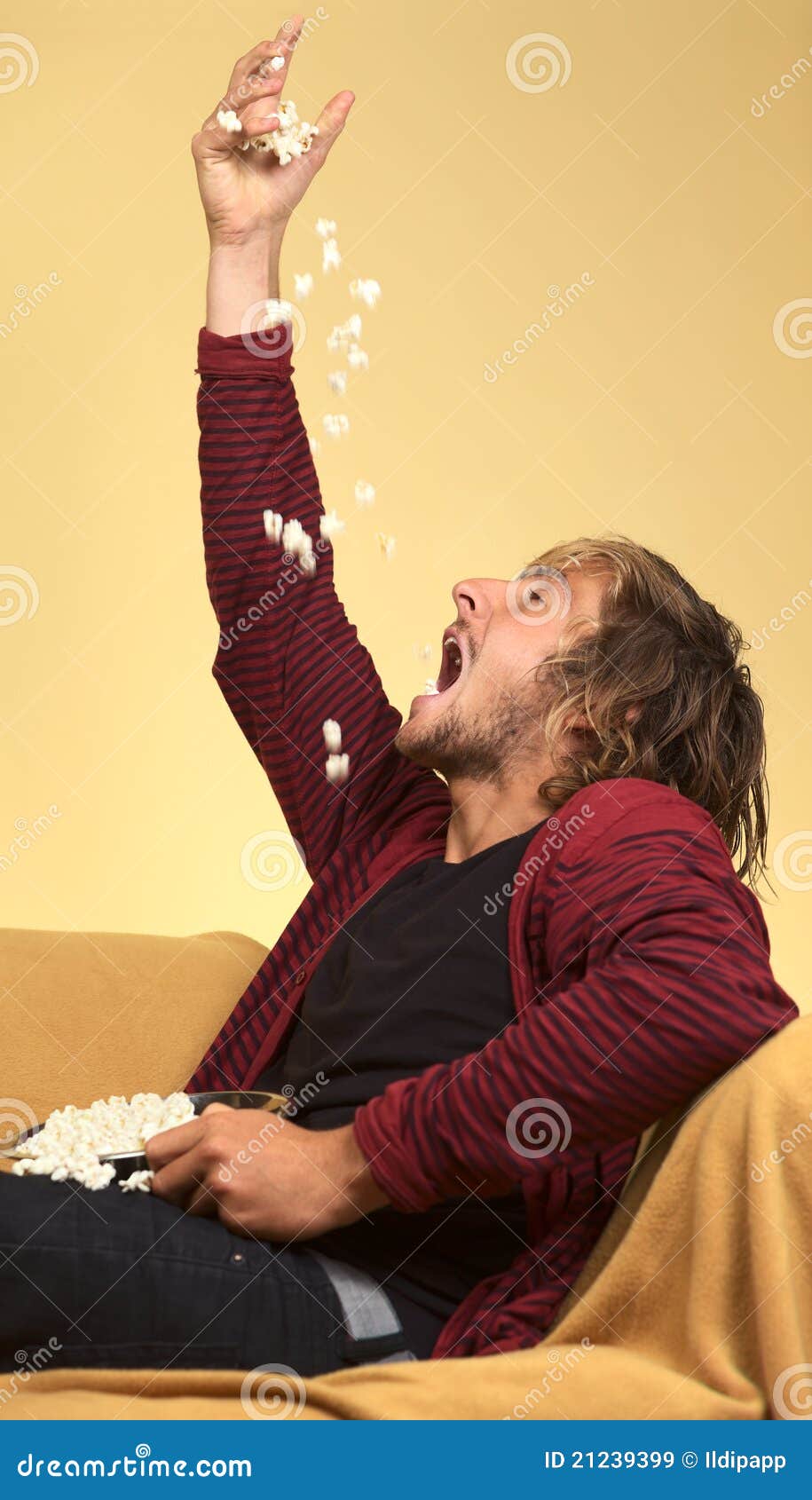 Young Man Eating Popcorn stock image. Image of portrait - 21239399