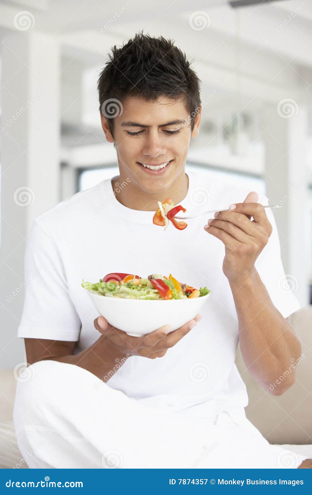 Young Man Eating a Salad stock image. Image of person - 7874357