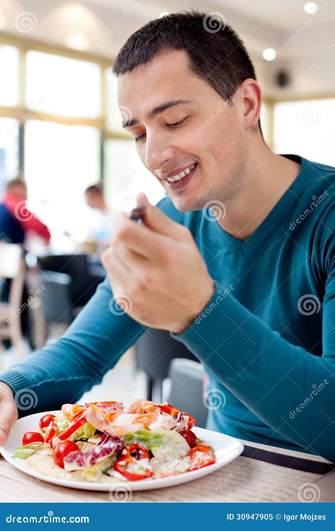 Young man eating stock image. Image of vegetables, restaurant - 30947905