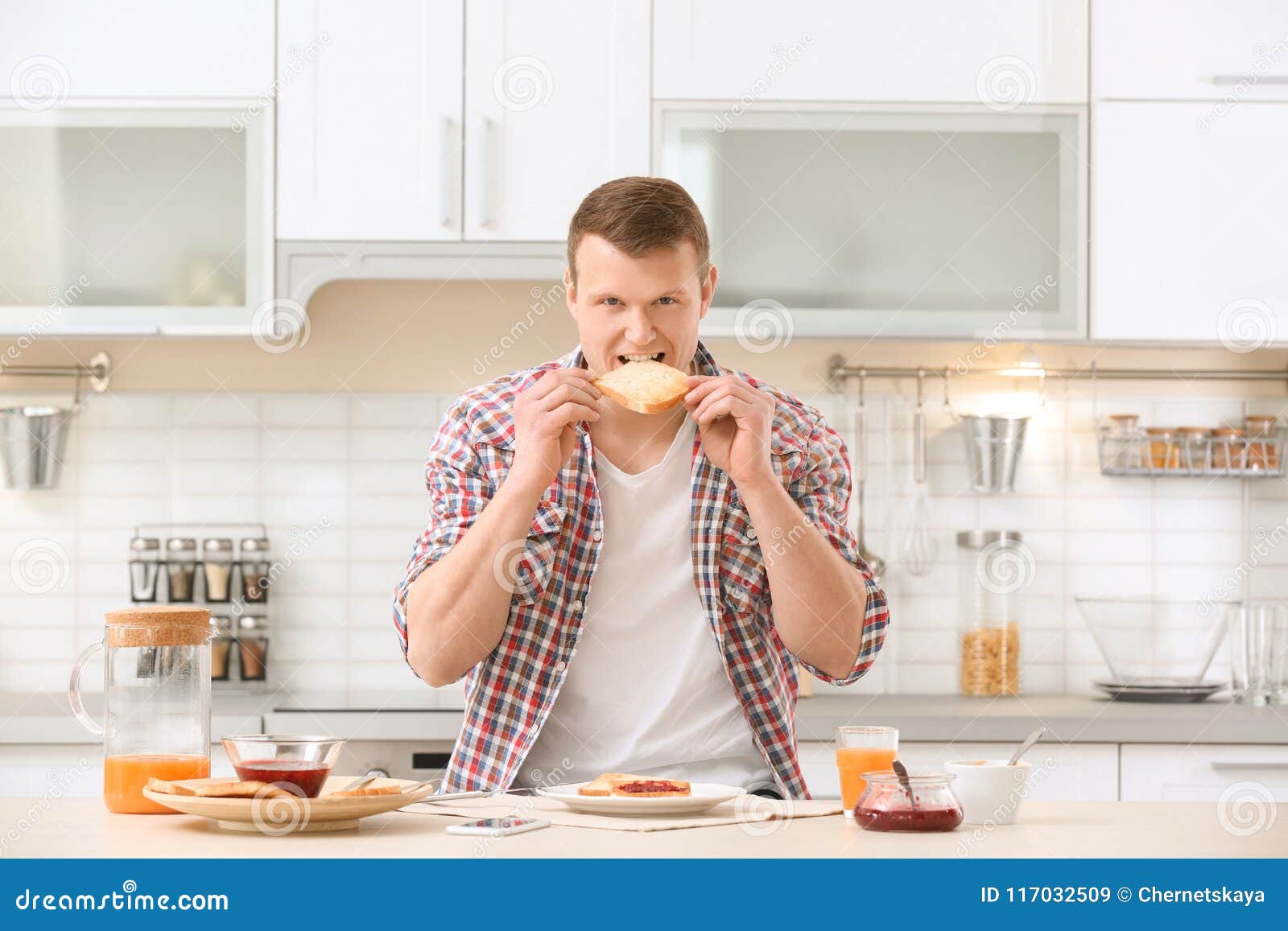 Young Man Eating Tasty Toasted Bread at Table Stock Image - Image of ... Young Man Eating Tasty Toasted Bread at Table Stock Image - Image of ...