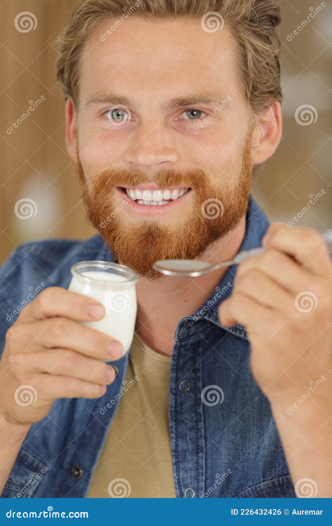 Young man eating yogurt stock photo. Image of dieting - 226432426