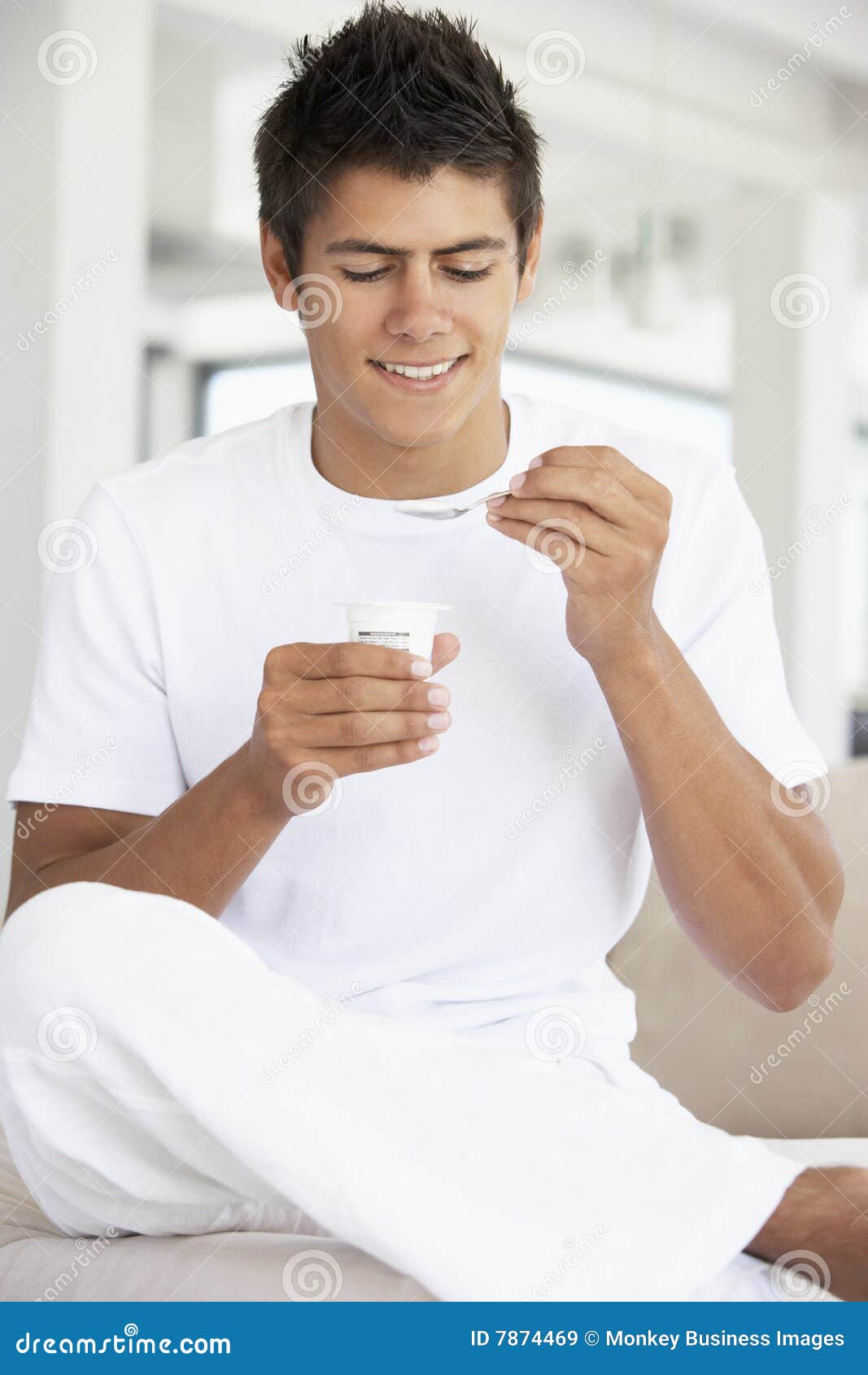 Young Man Eating Yogurt stock image. Image of hair, colour - 7874469