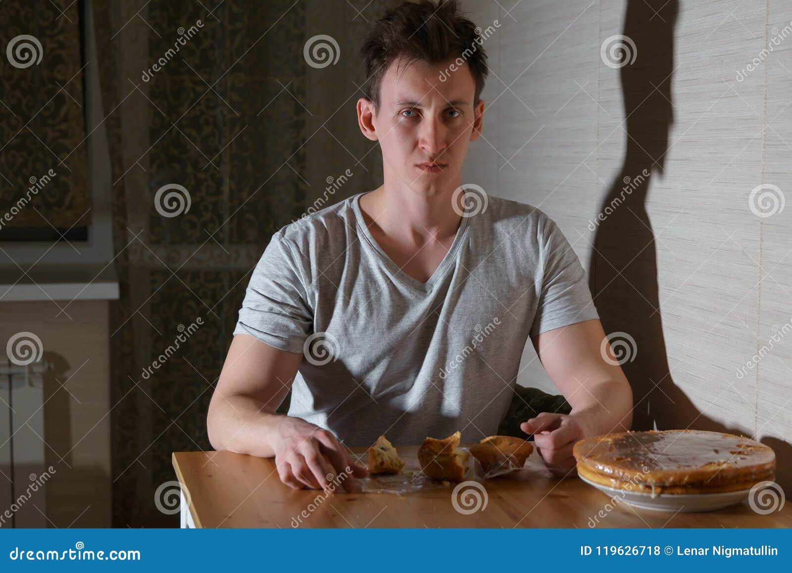 Young Man Eats Sweets in the Kitchen at Night Stock Photo - Image of ...