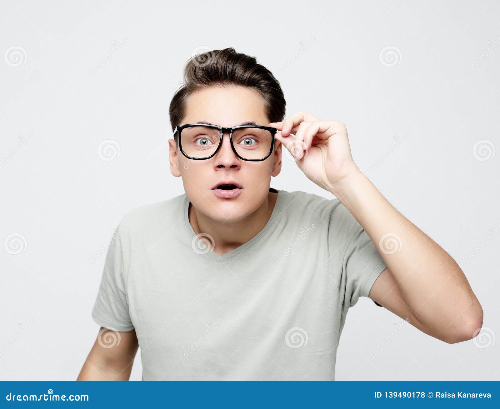 Young Man with Emotions on His Face a Grey Background Stock Photo ...
