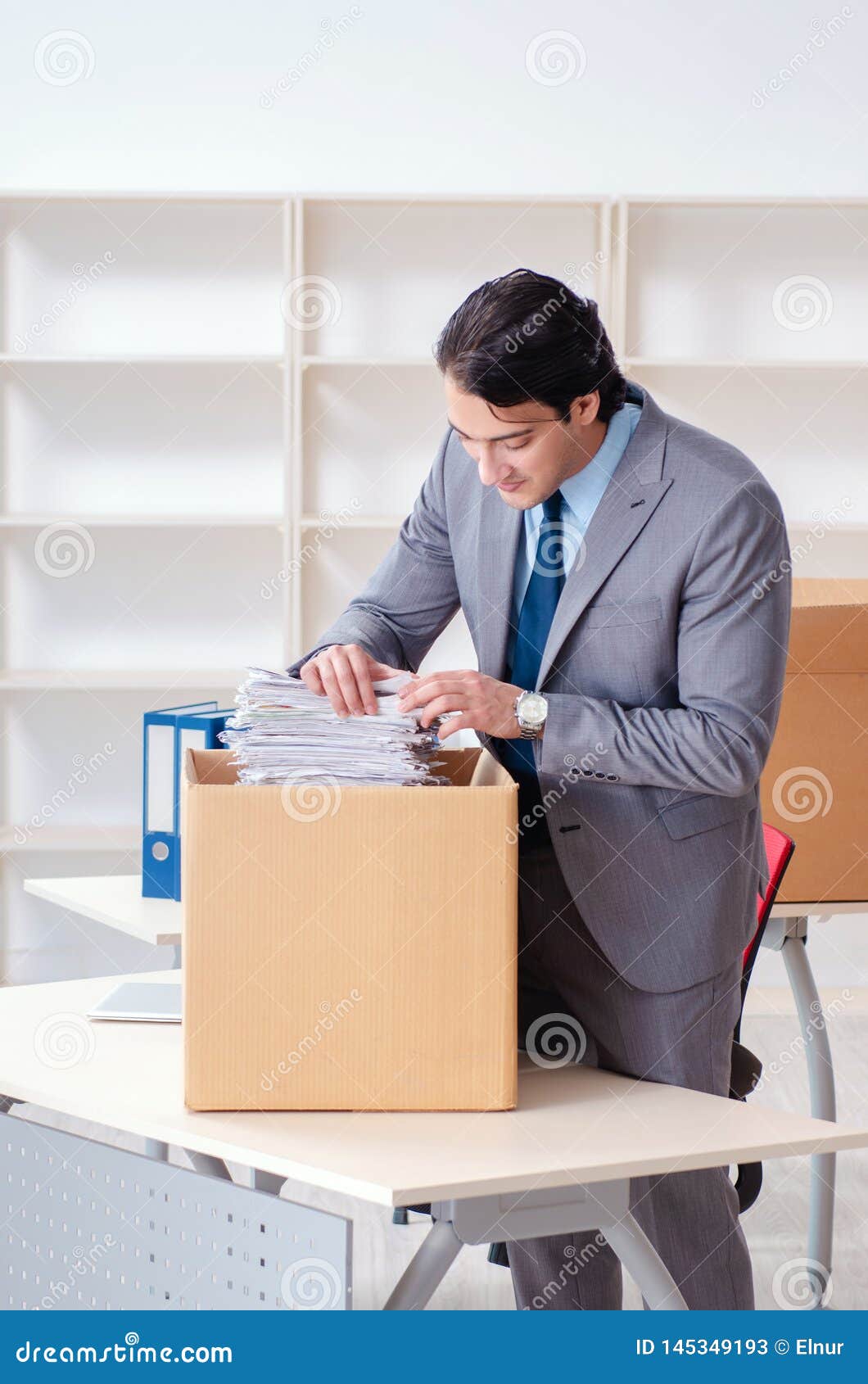 The Young Man Employee with Boxes in the Office Stock Image - Image of ...