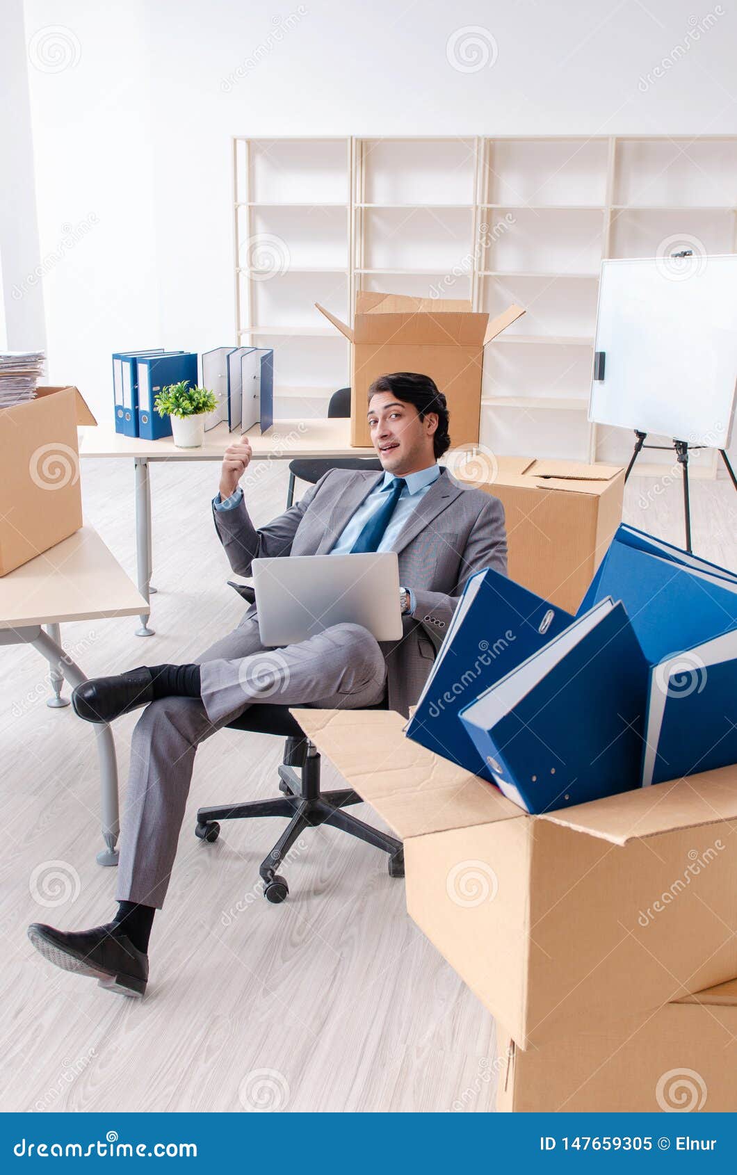 The Young Man Employee with Boxes in the Office Stock Image - Image of ...