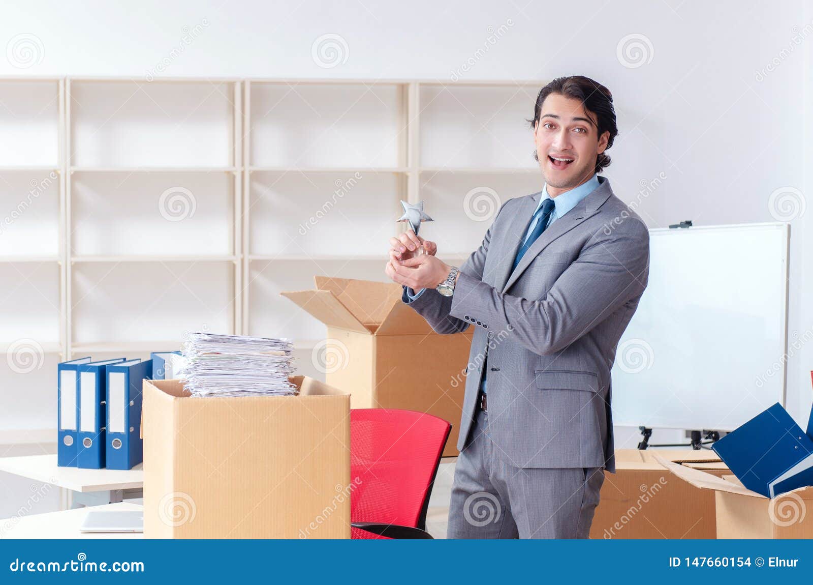 The Young Man Employee with Boxes in the Office Stock Photo - Image of ...