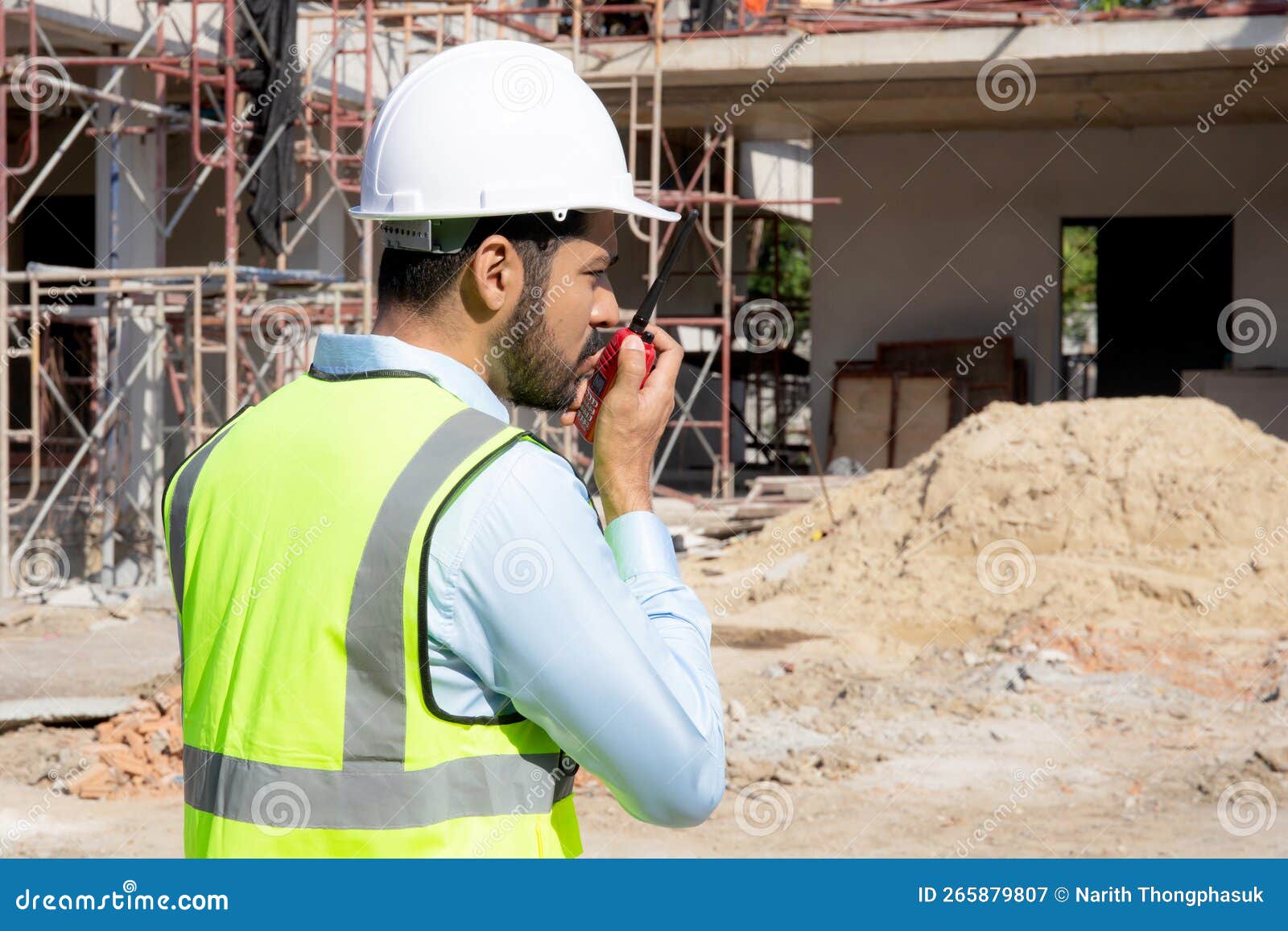 Young Man Engineer Using Radio Command with Worker in Construction Site ...