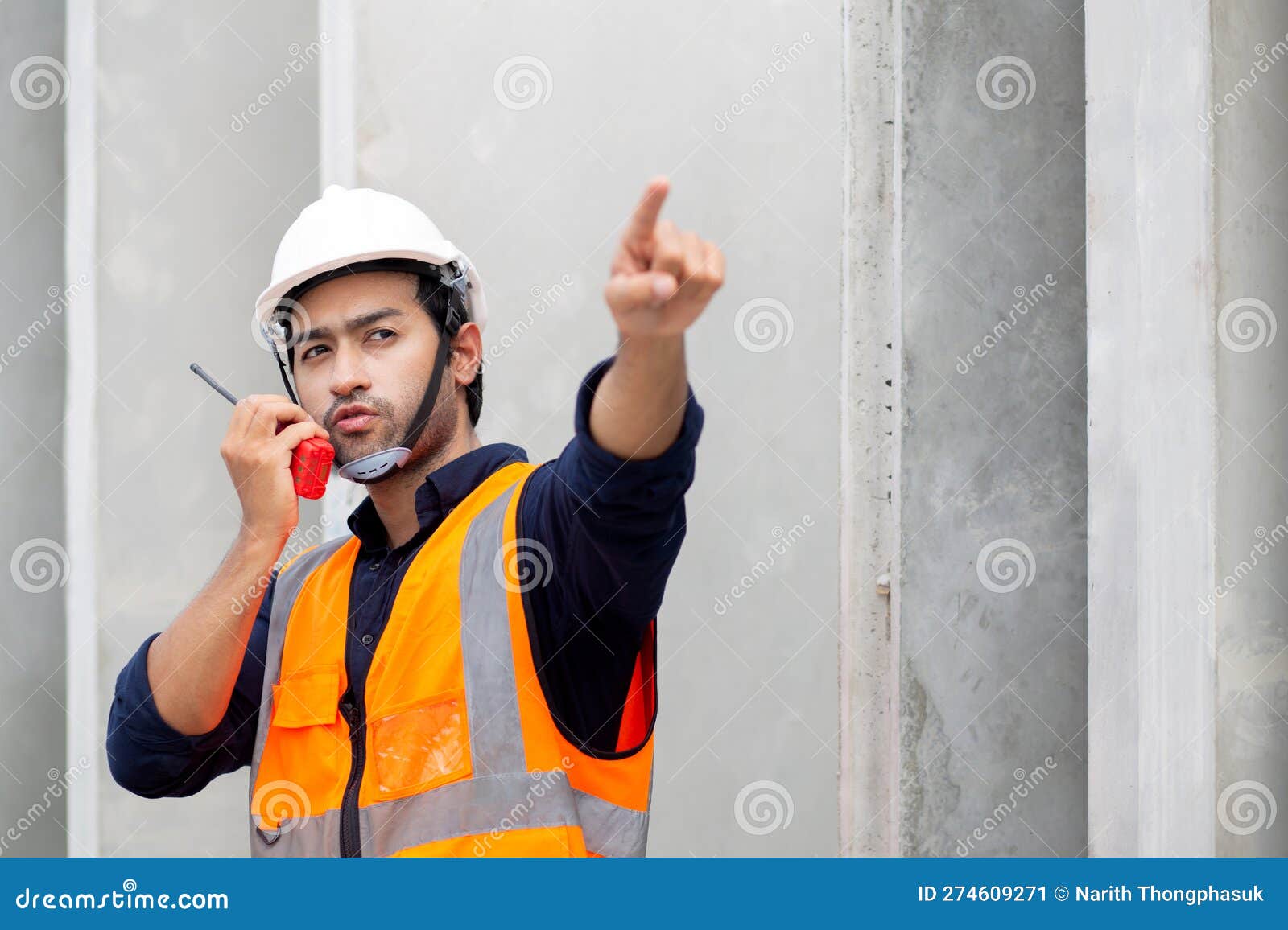 Young Man Engineer Using Radio Command with Worker in Construction Site ...