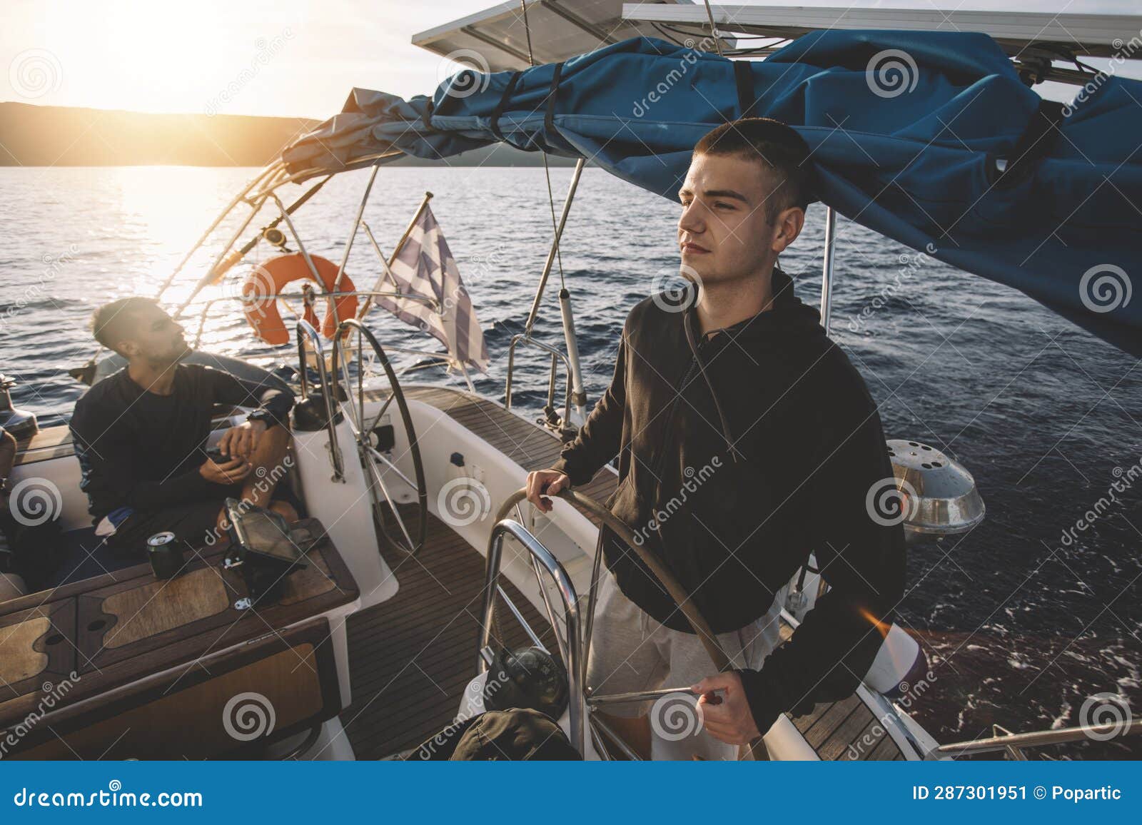 Young man at the helm stock image. Image of nautical - 287301951