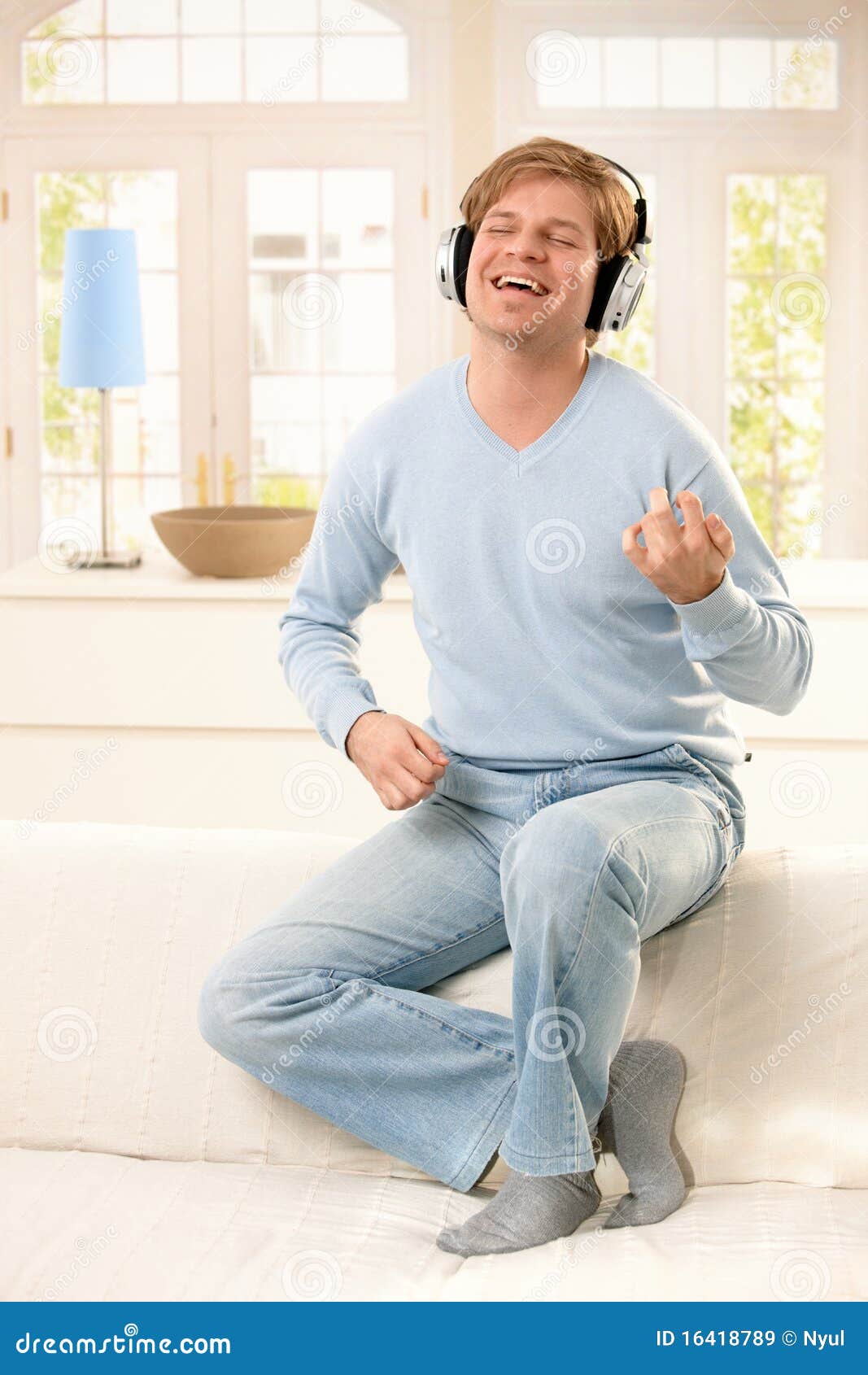 Young man enjoying music stock image. Image of indoor - 16418789