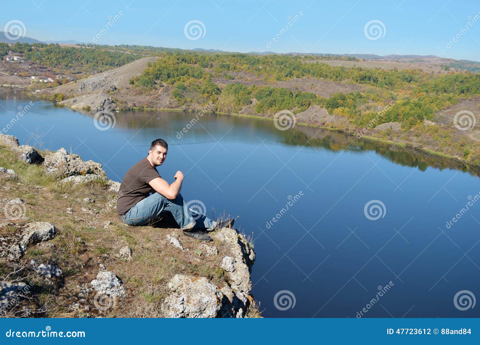 Young Man Enjoying the View of a Beautiful Lake Stock Photo - Image of ...