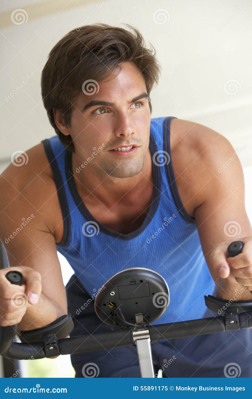 Young Man on Exercise Bike stock image. Image of working - 55891175