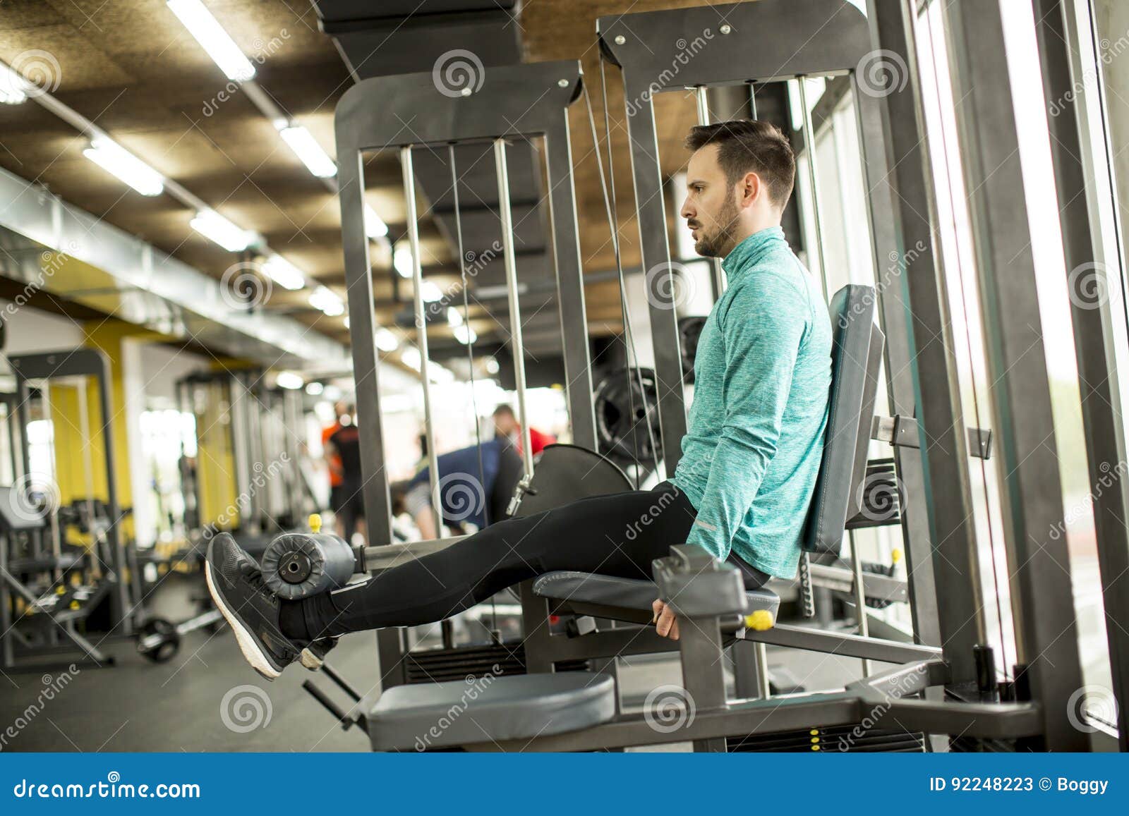 Young Man Exercise on an Exercise Machine at the Gym Stock Image ...