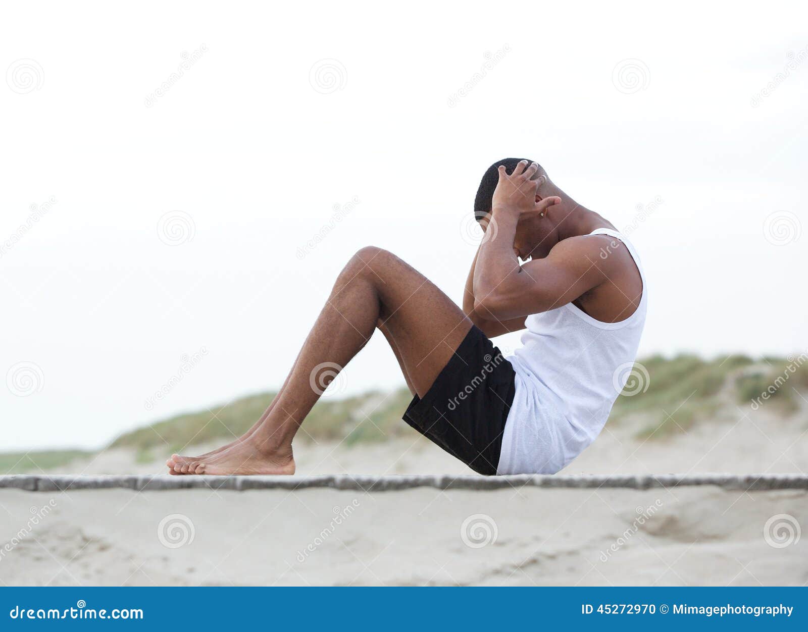 Young Man Exercising on the Beach Doing Sit Ups Stock Photo - Image of ...