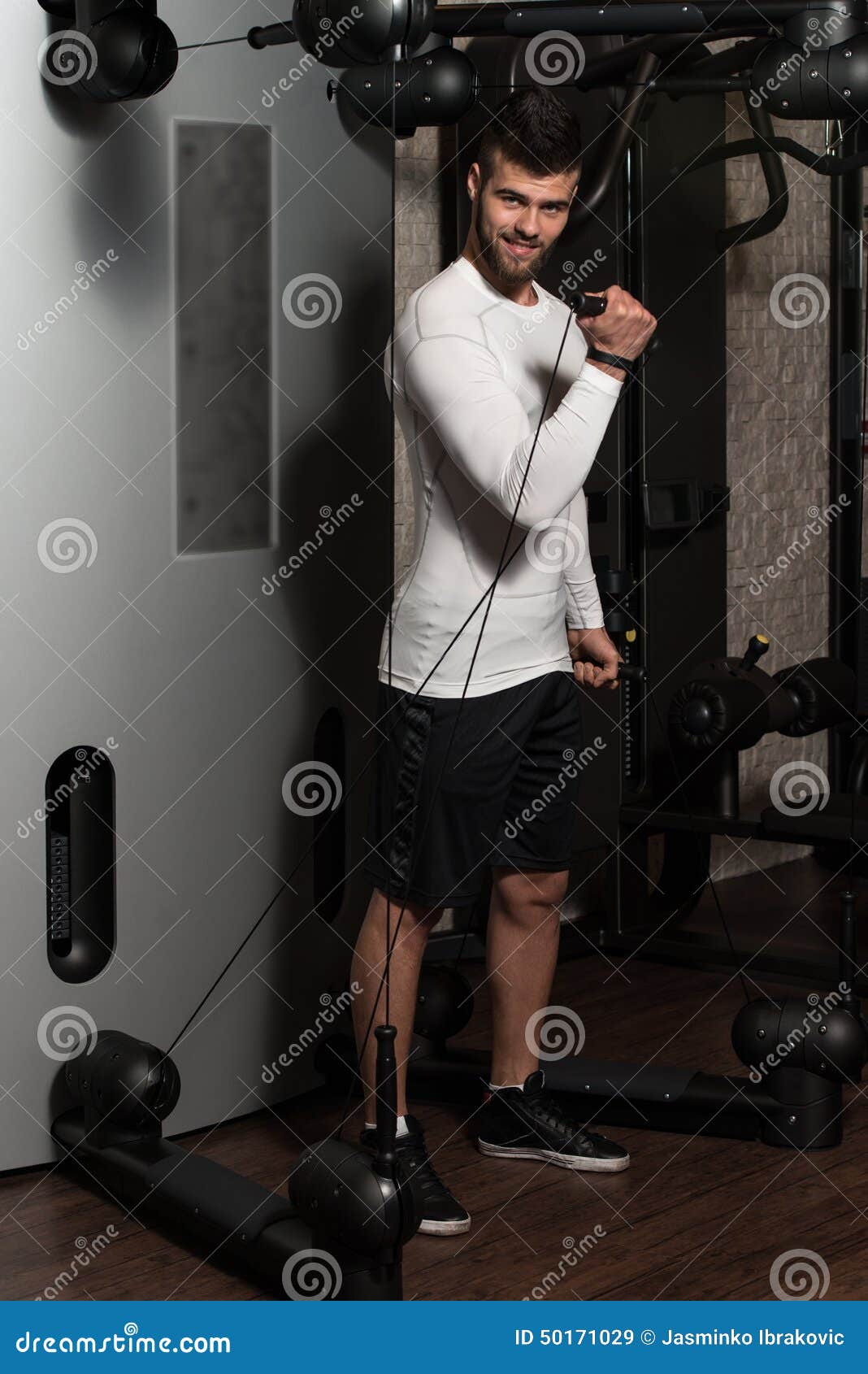 Young Man Exercising Biceps on Machine Stock Image - Image of fitness ...