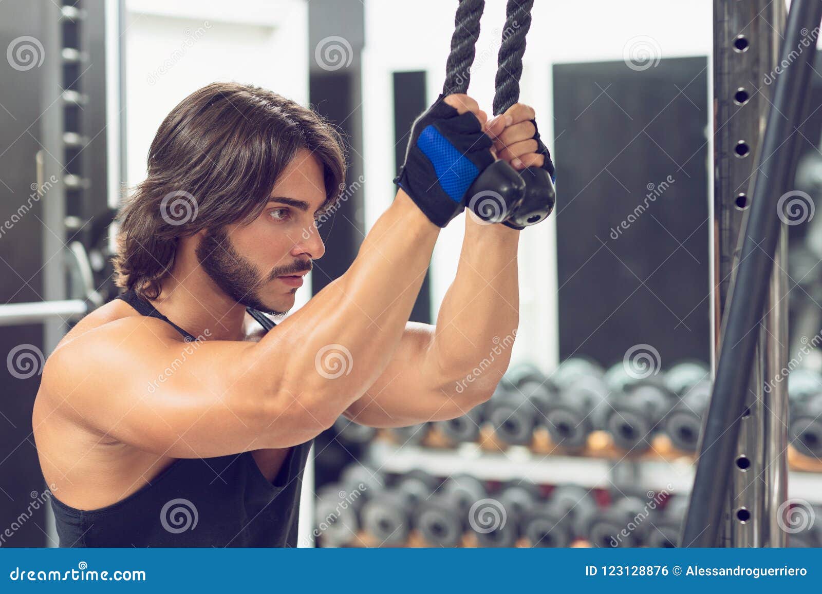 Young Man Exercising Triceps Pulldown at the Gym Stock Photo - Image of ...