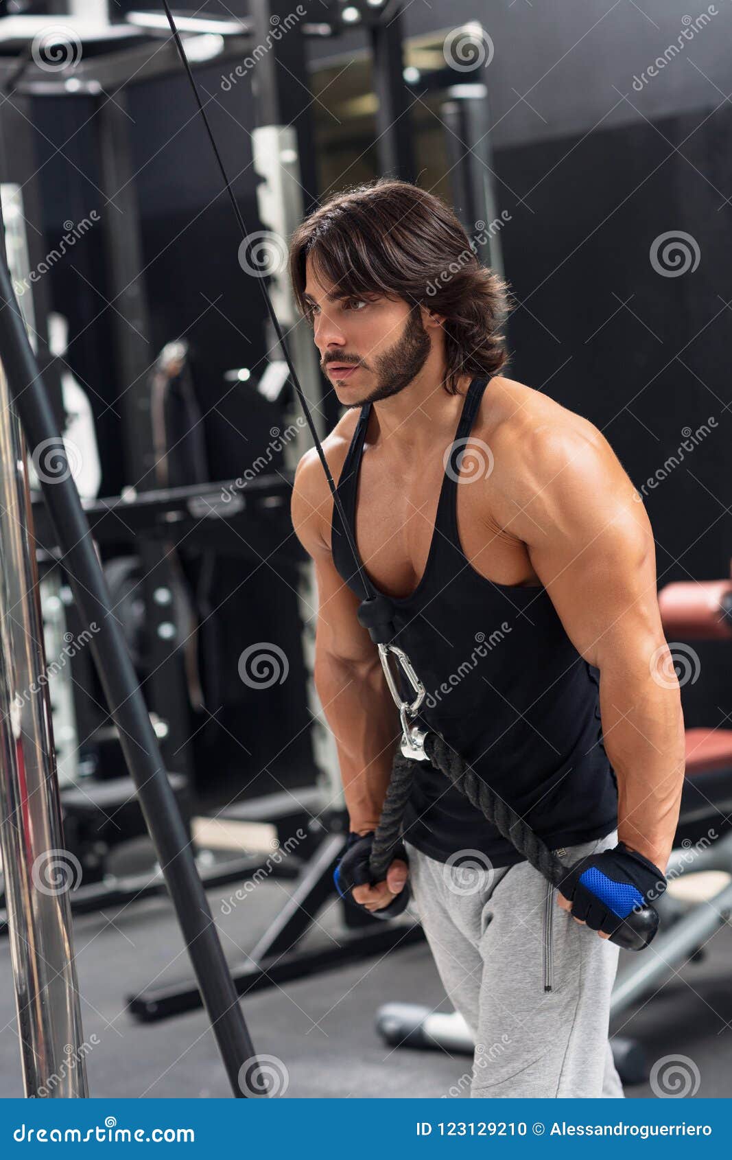 Young Man Exercising Triceps Pulldown at the Gym Stock Photo - Image of ...