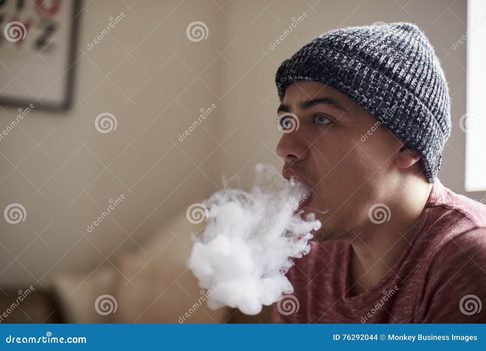 Young Man Exhaling Whilst Using Vapourizer Stock Photo - Image of ...