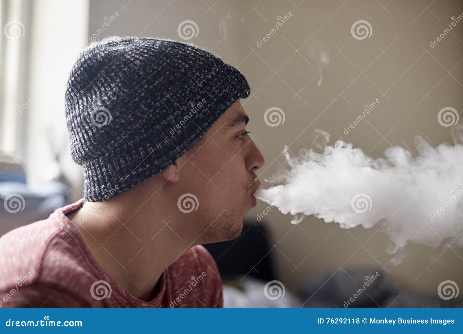 Young Man Exhaling Whilst Using Vapourizer Stock Photo - Image of ...
