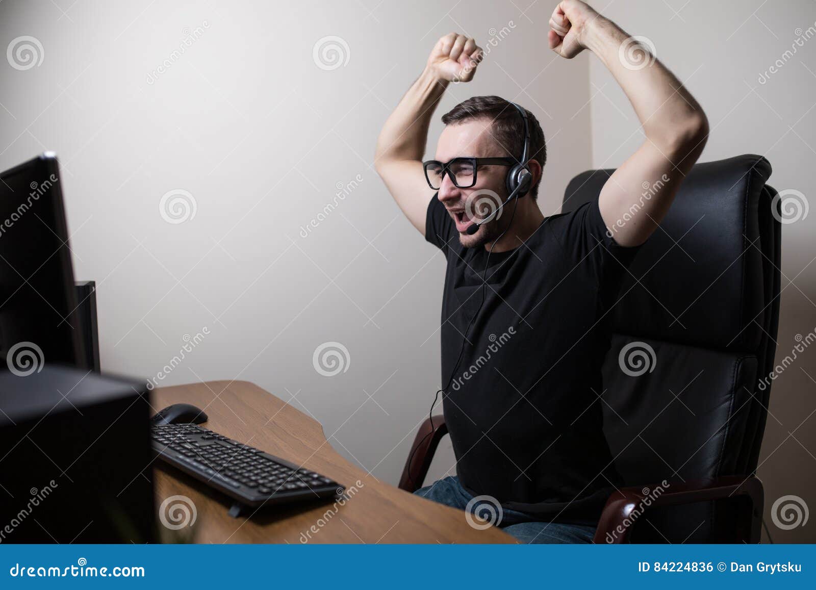Young Man in Eyeglasses with Headset Playing and Winning Computer Game ...