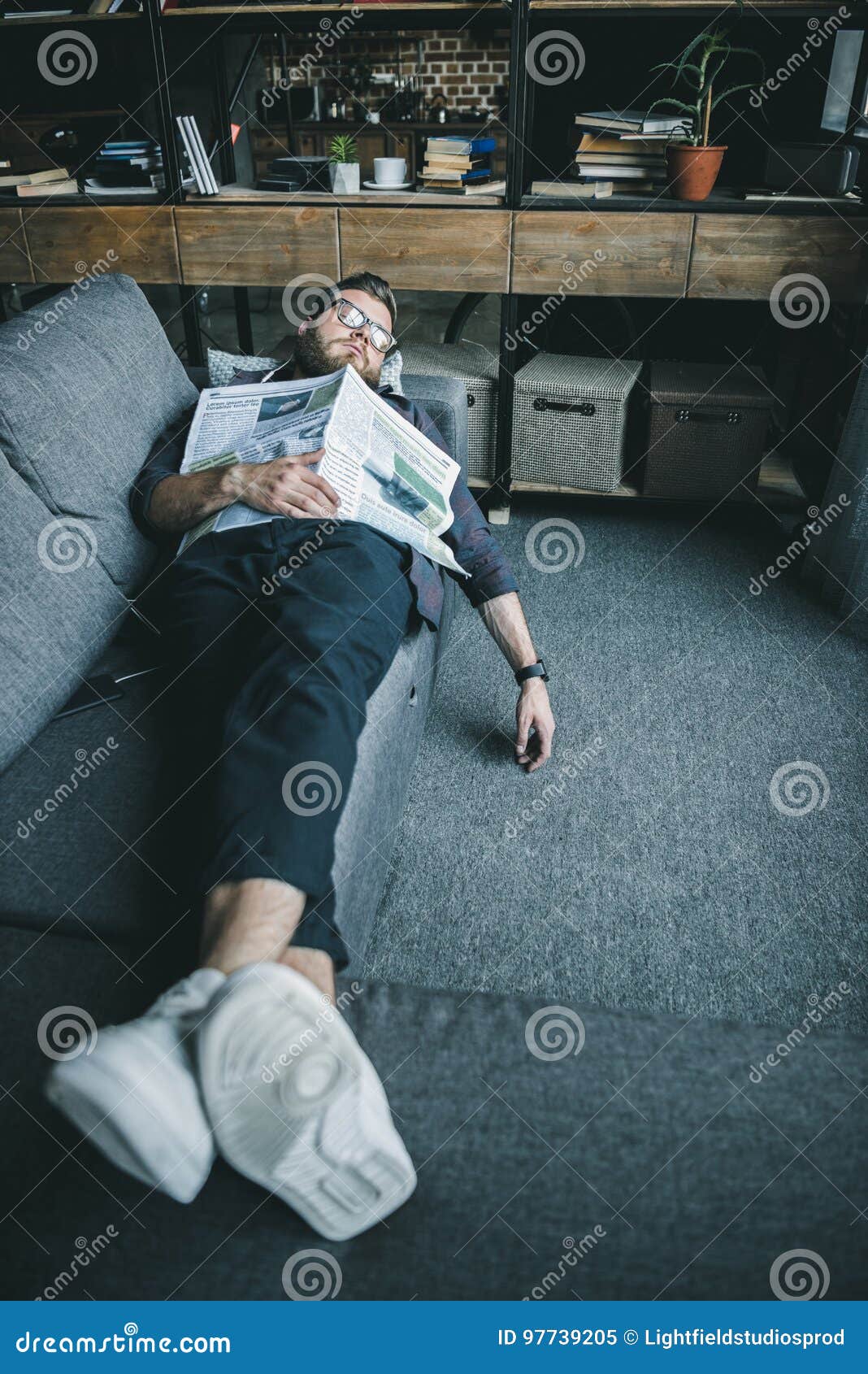 Young Man in Eyeglasses Sleeping with Newspaper on Sofa at Home Stock ...