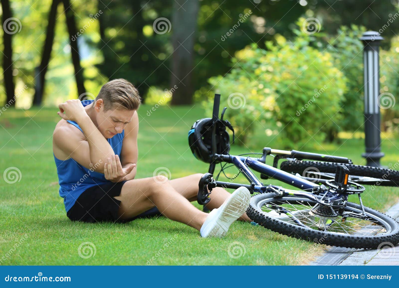 Young Man Fallen Off His Bicycle in Park Stock Photo - Image of fallen ...