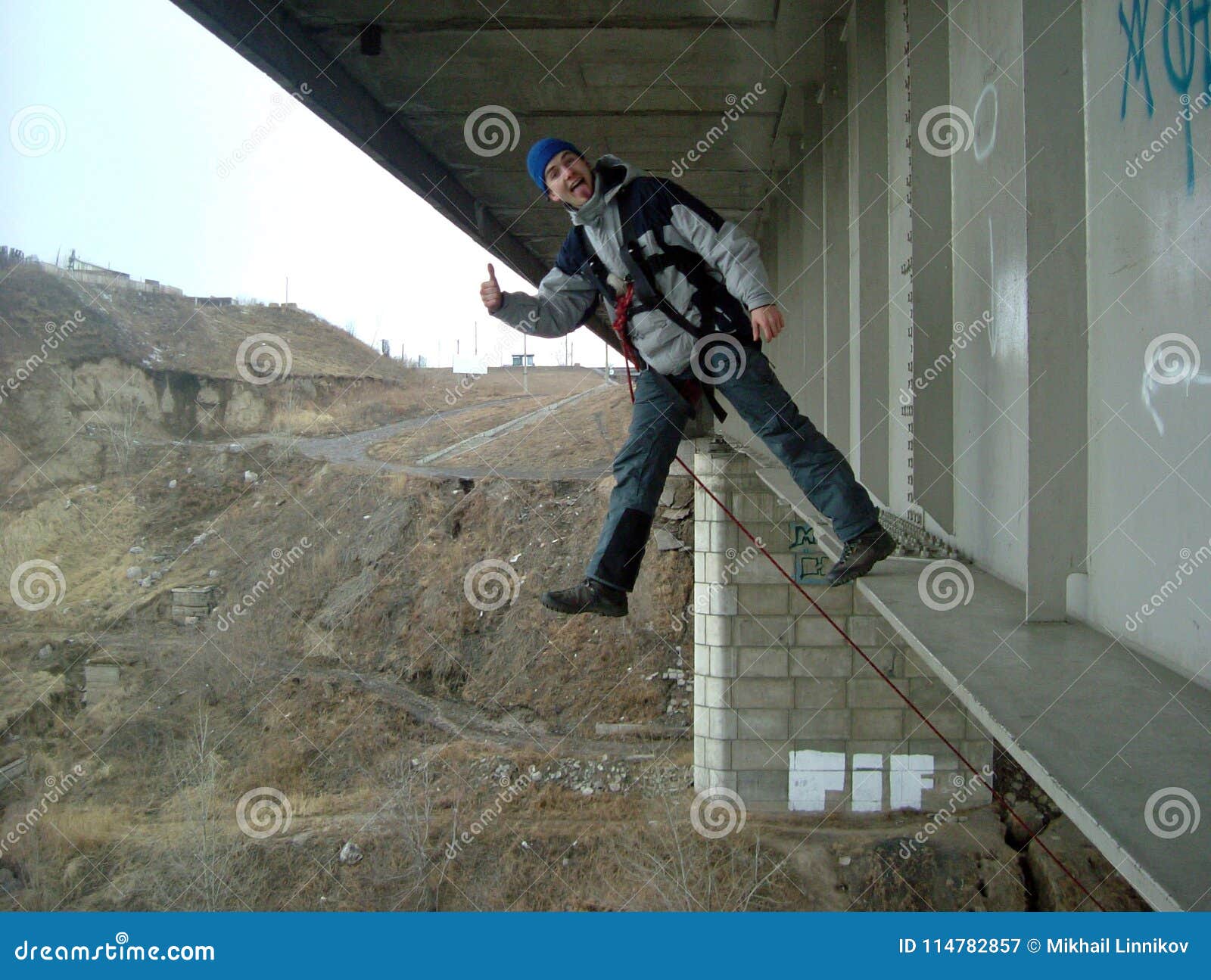 The Young Man Falls from the Bridge and Smiles. Stock Image - Image of ...