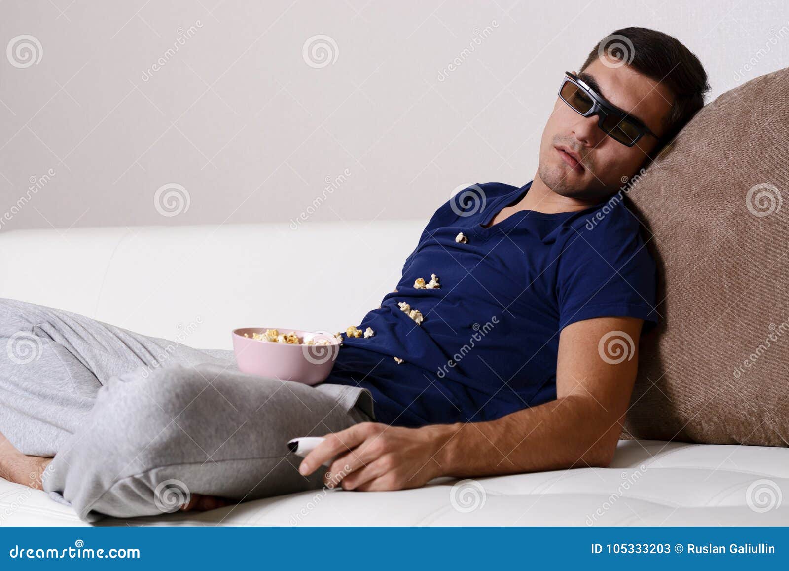 A Young Man Fell Asleep while Watching TV in 3D Glasses with Popcorn ... A Young Man Fell Asleep while Watching TV in 3D Glasses with Popcorn ...