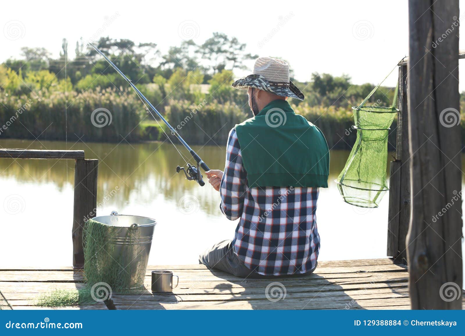 Young man fishing alone stock photo. Image of catch - 129388884