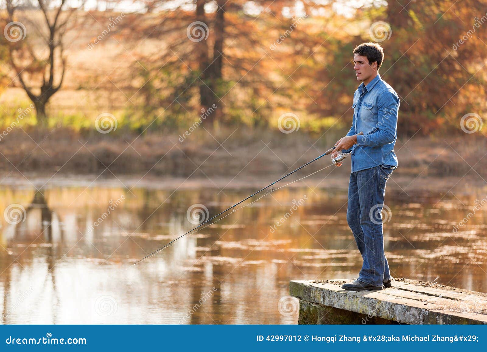 Young man fishing stock photo. Image of fall, concentrate - 42997012