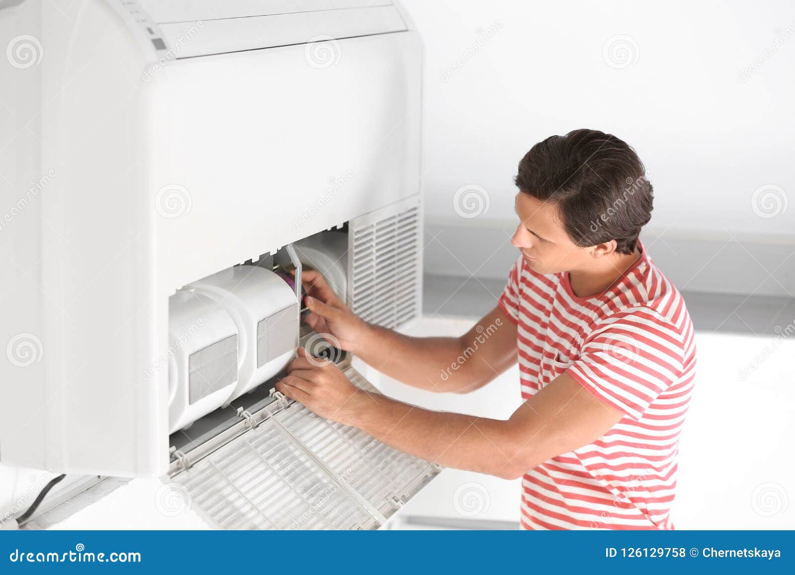 Young Man Fixing Air Conditioner Stock Photo - Image of indoors ...