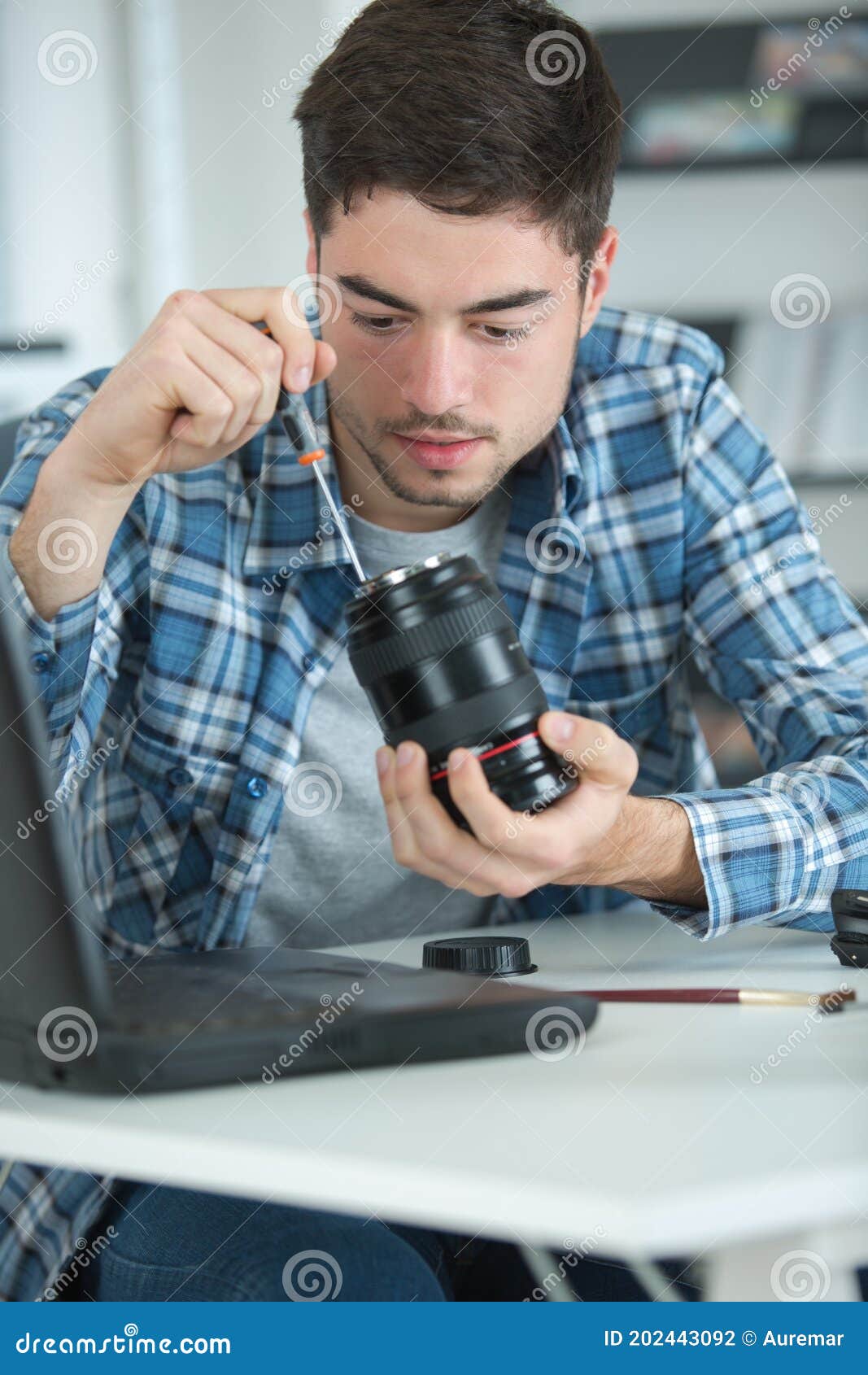 Young man fixing camera stock photo. Image of repair - 202443092