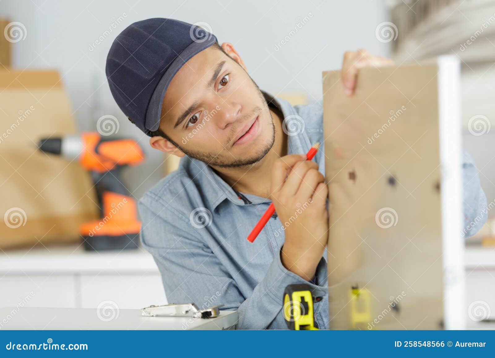 Young man fixing cupboard stock photo. Image of person - 258548566