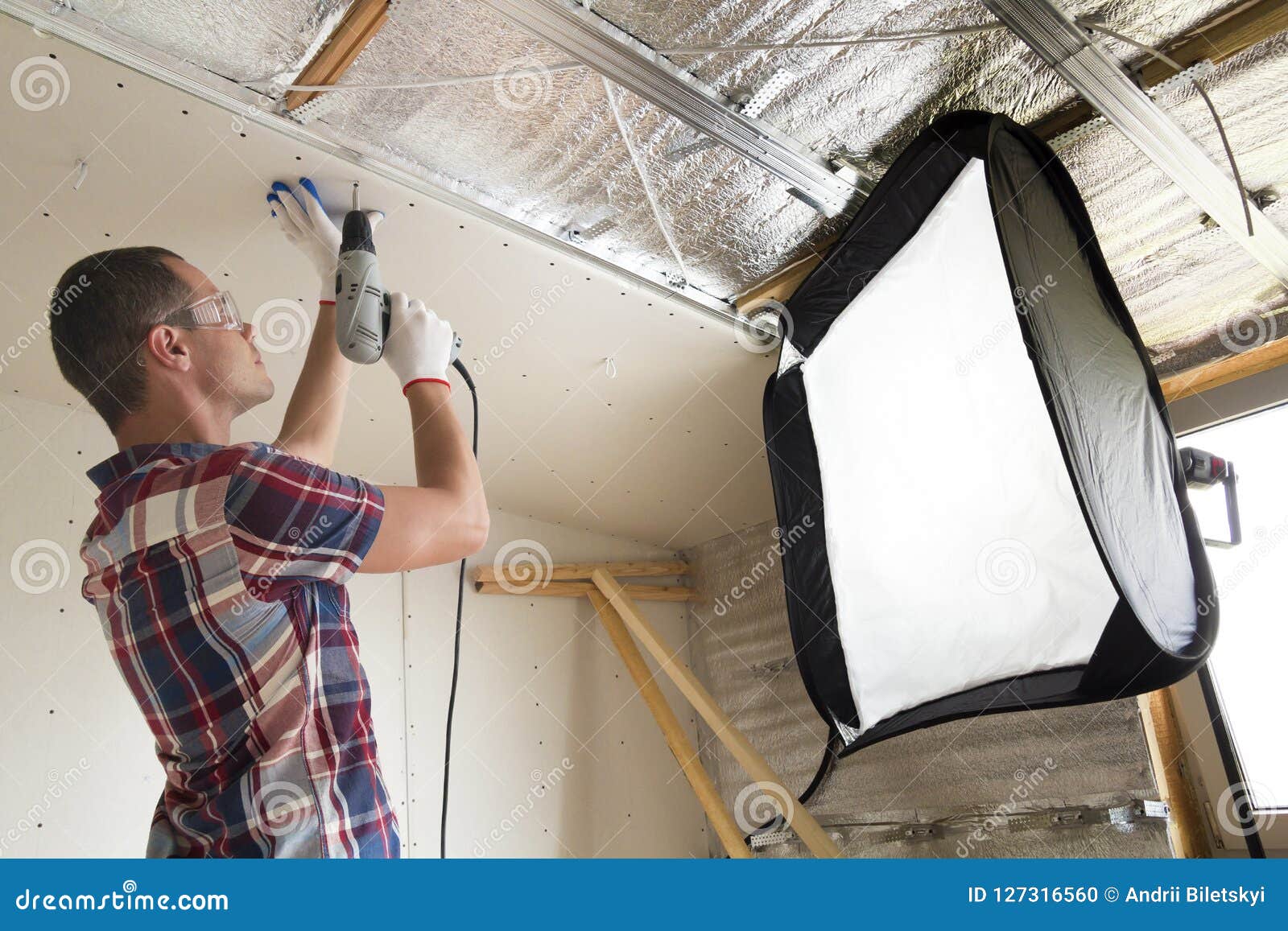 Young Man Fixing Drywall Suspended Ceiling To Metal Frame Using ...