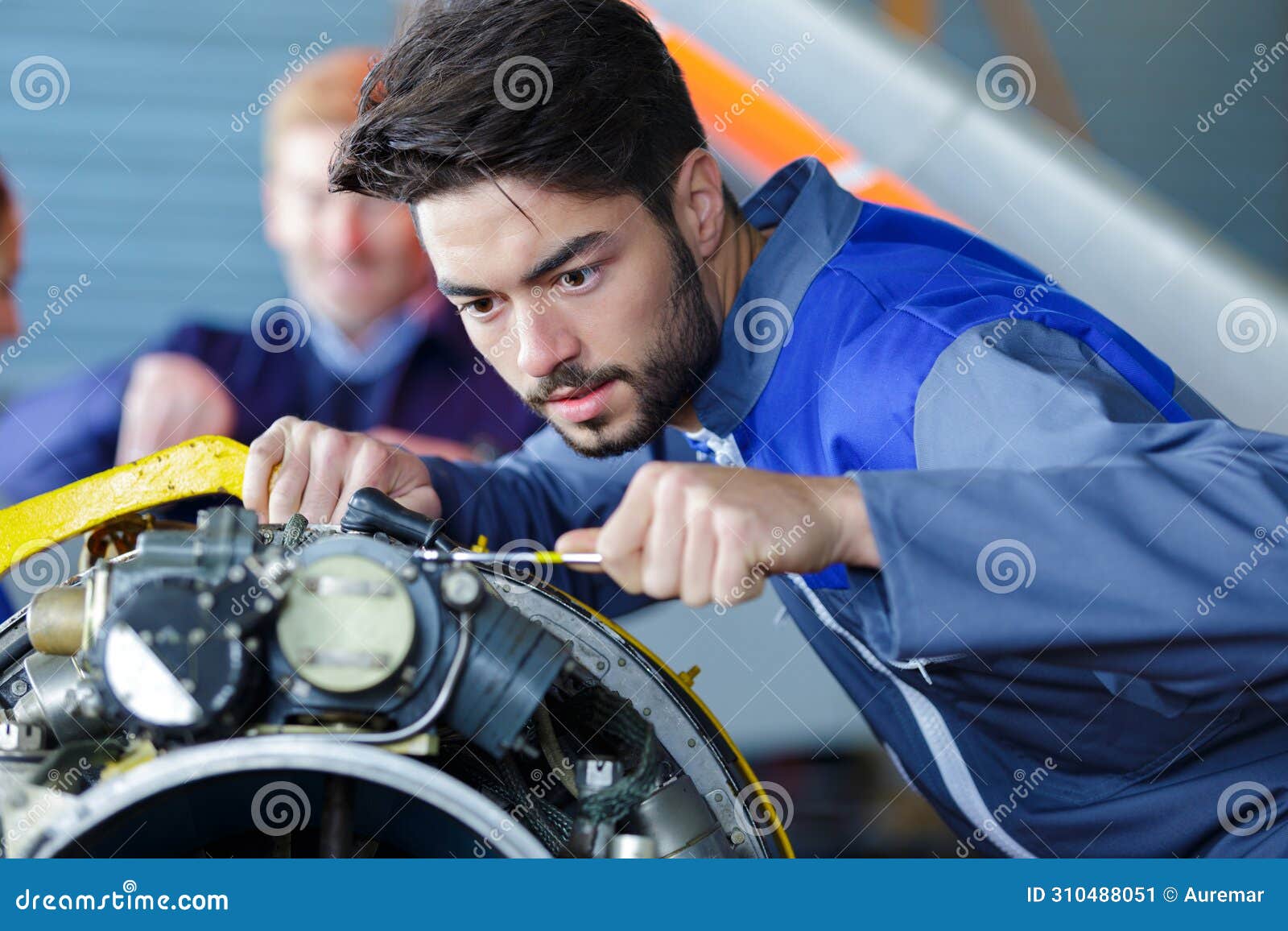 Young man fixing machine stock image. Image of tightened - 310488051