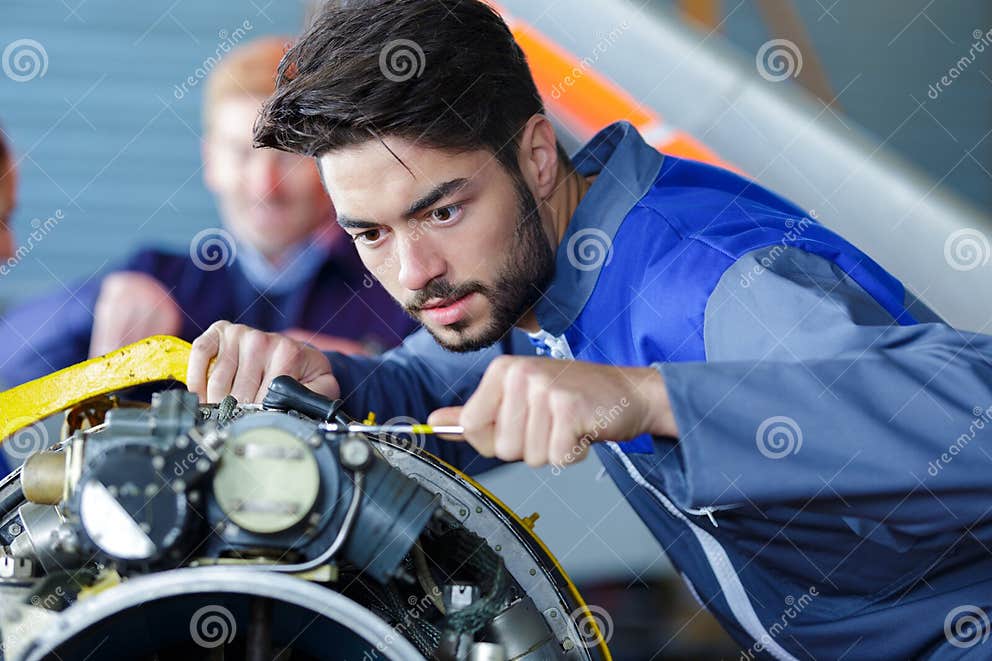 Young man fixing machine stock image. Image of tightened - 310488051