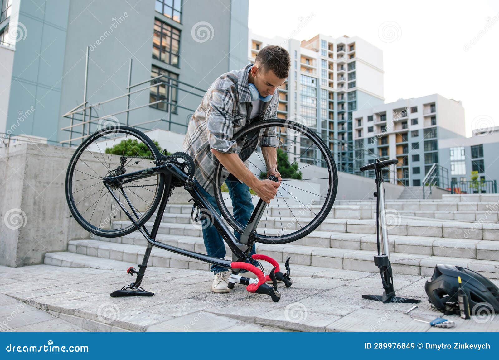 Young Man Fixing a Problem with the Tire Stock Image - Image of ...