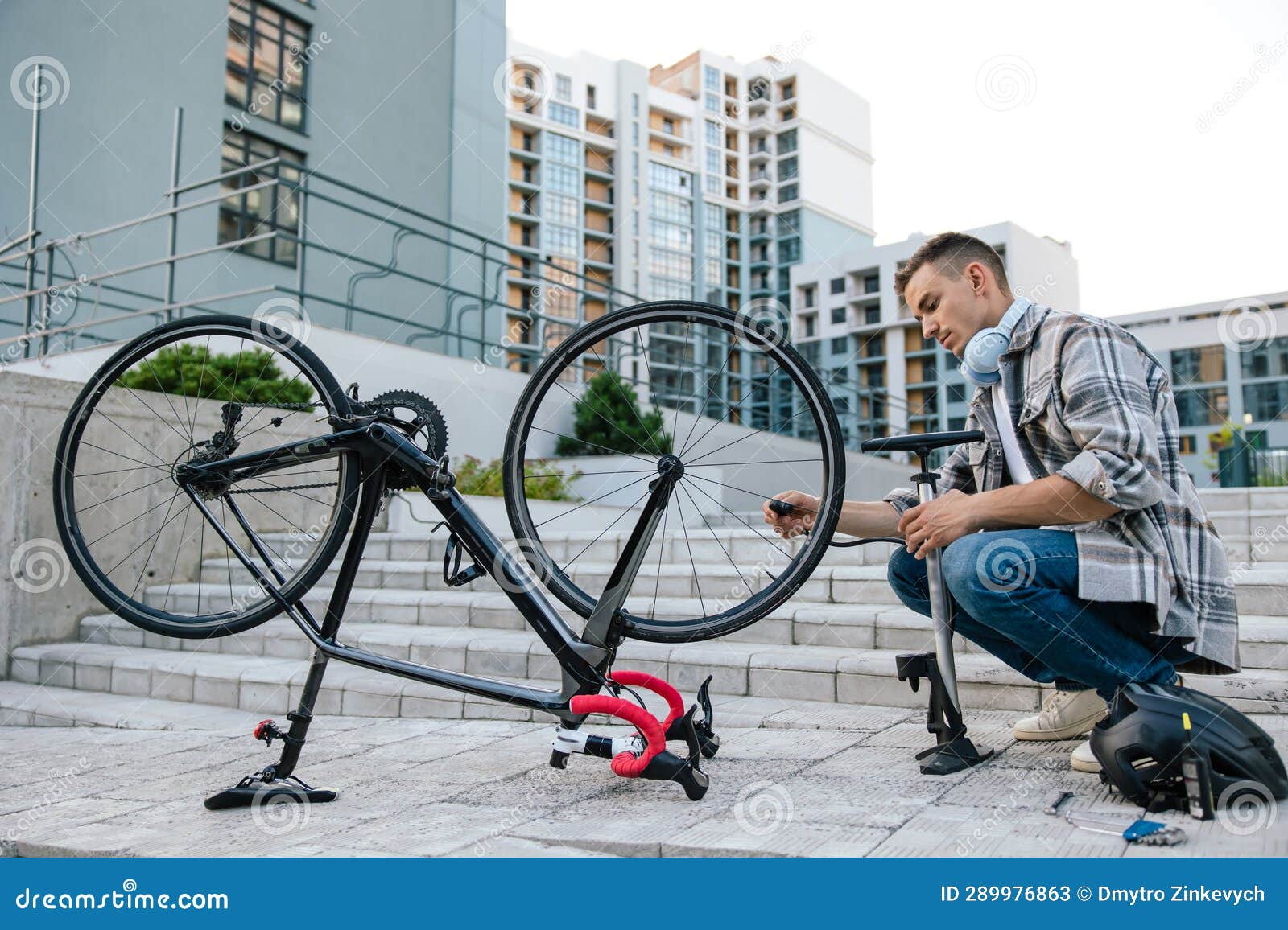 Young Man Fixing a Problem with the Tire Stock Image - Image of ...