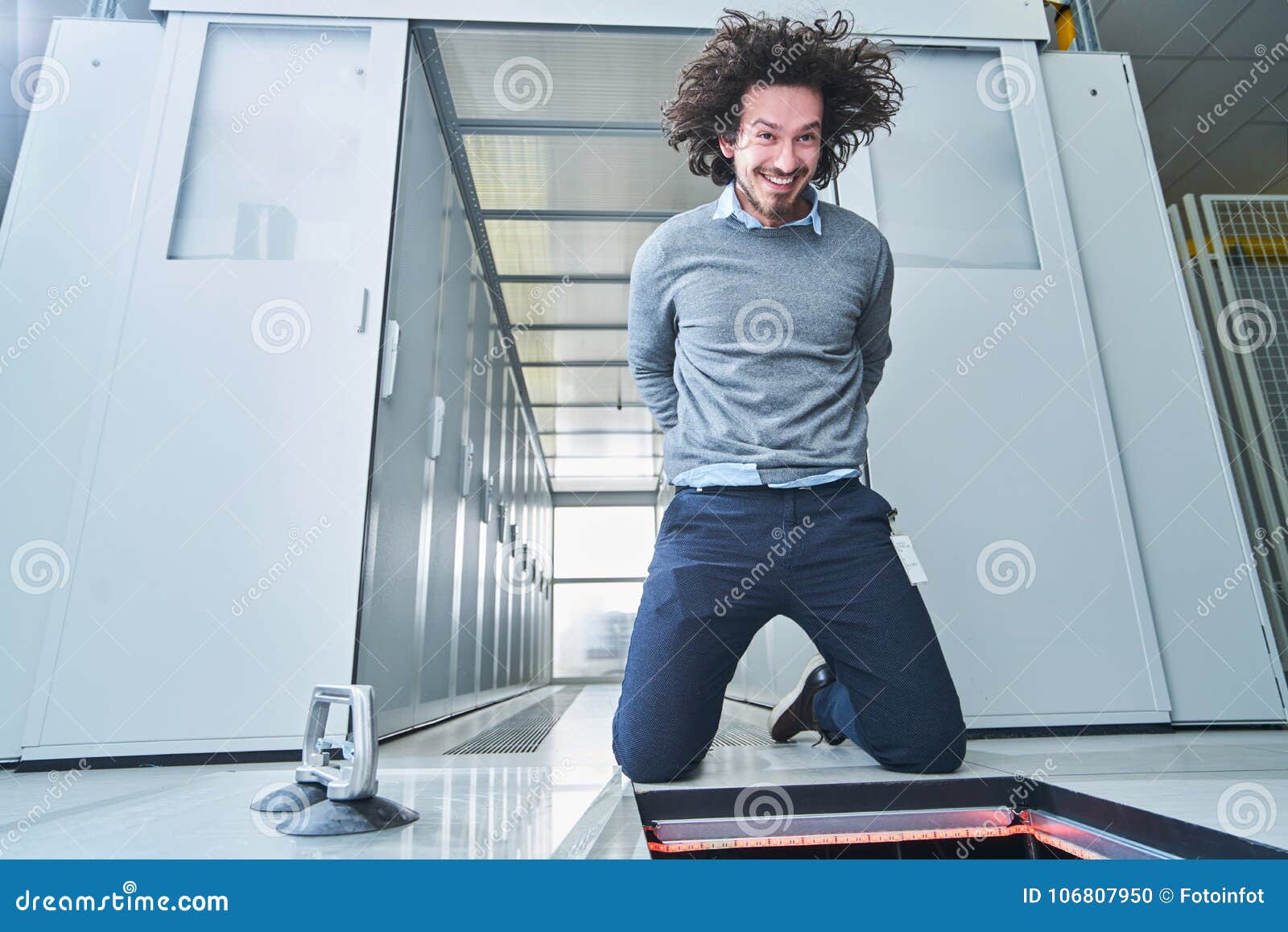 Young Man Fixing Something in the Floor Hatch. Data Center Stock Photo ...