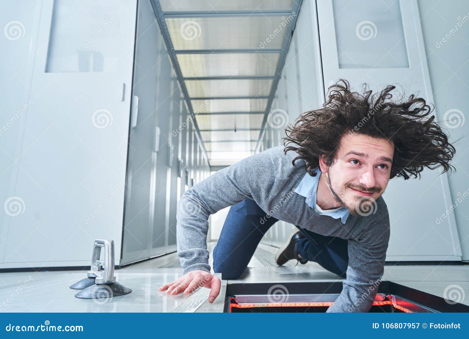Young Man Fixing Something in the Floor Hatch. Data Center Stock Image ...